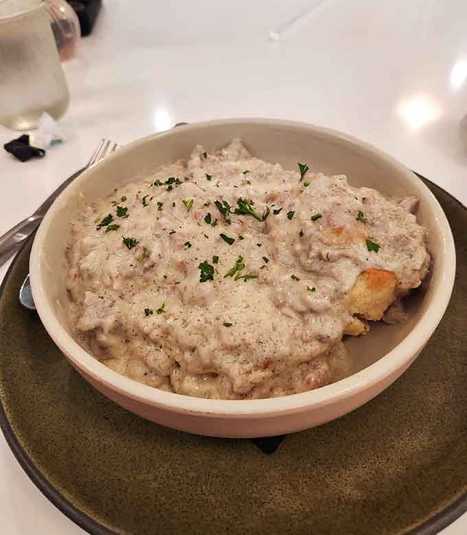 Behold the star of the show: fluffy biscuits drowning in creamy sausage gravy that'll make you believe in breakfast again.