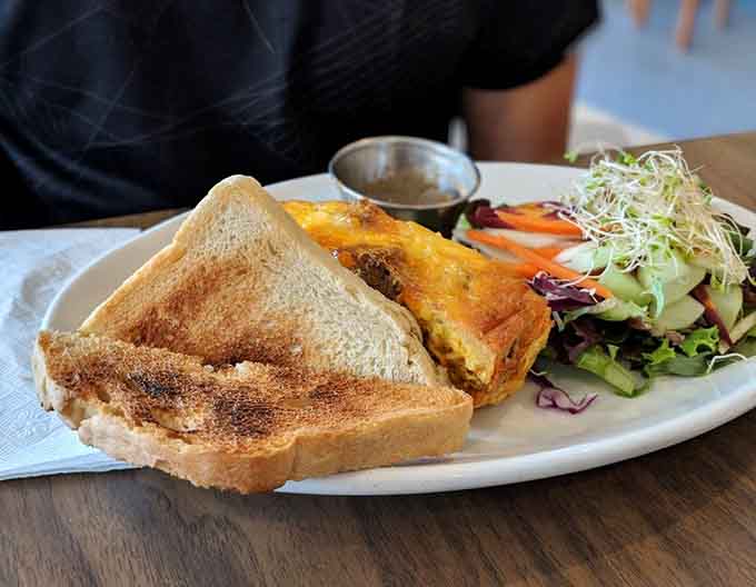 Behold the frittata that launched a thousand return visits: fluffy eggs embracing local ingredients with a side salad that actually looks appetizing.