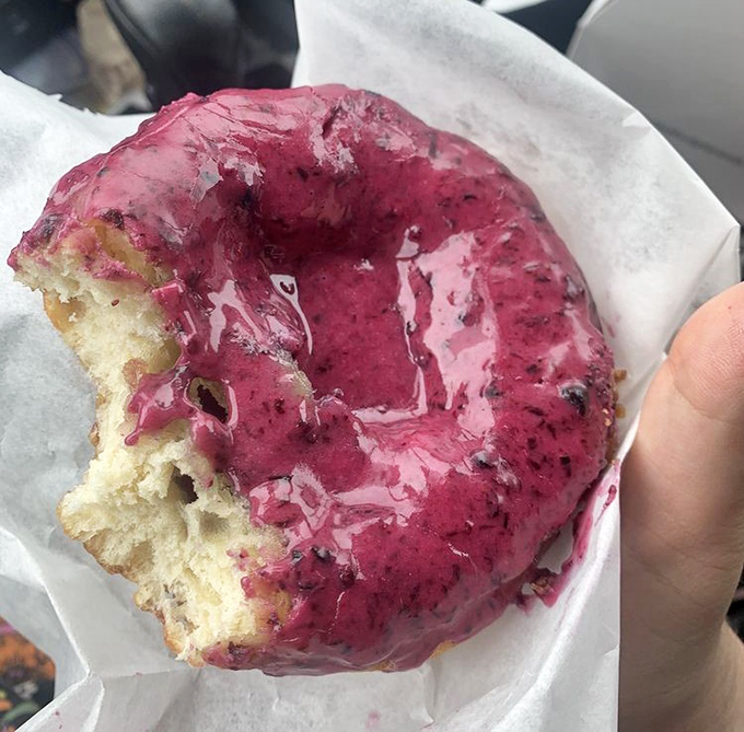 This Triple Berry Cannoli donut isn't just a treat &ndash; it's a vibrant purple masterpiece with a dollop of cream that makes other breakfast pastries look like they're not even trying.