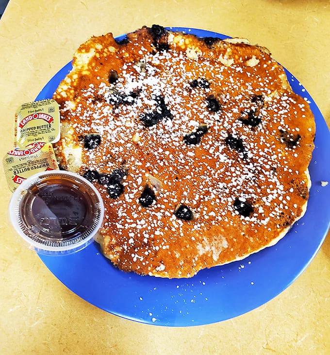 These blueberry pancakes aren't playing games&mdash;perfectly golden with berries distributed by someone who clearly understands the importance of proper blueberry placement.