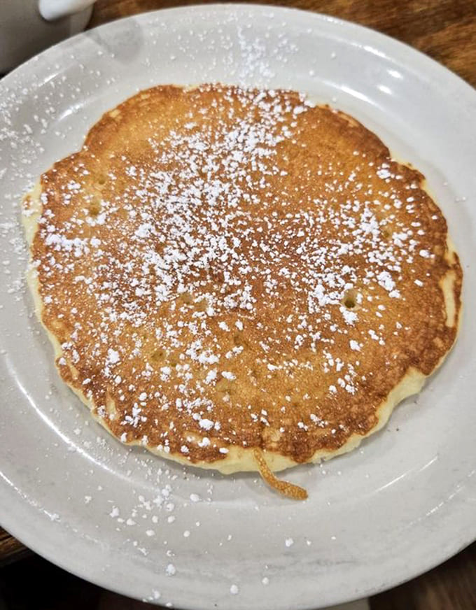 Behold the classic pancake in all its golden, powdered-sugar-dusted glory, simple perfection on a plate.