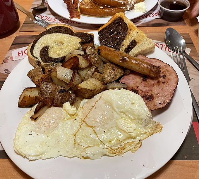 A classic breakfast plate featuring perfectly cooked eggs, crispy hash, and that signature marbled toast that deserves its own fan club.
