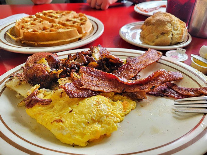Breakfast symphony on a plate &ndash; golden waffles, crispy bacon, and eggs that make you question if you've ever truly experienced breakfast before.
