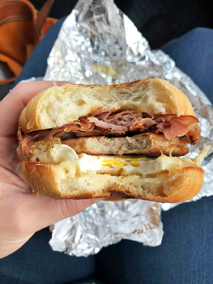 Breakfast sandwich perfection: golden egg, crispy ham, and melty cheese nestled in a fresh-baked roll. Morning salvation wrapped in foil.