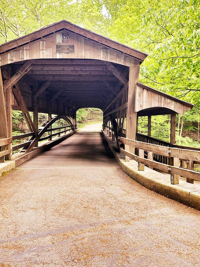 Inside the covered bridge, time slows down as sunlight filters through wooden slats, creating patterns that no smartphone camera can truly capture.