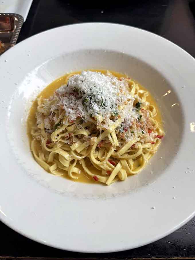 Linguine that's been treated right, coated in sauce that knows its place, topped with cheese that adds the perfect finishing touch.