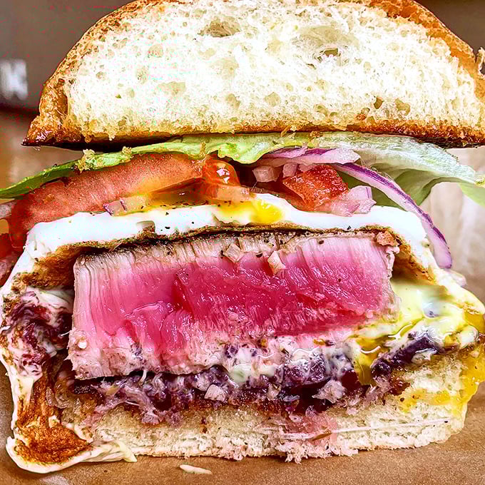 This isn't just dinner, it's edible art &ndash; perfectly seared tuna, runny egg, and fresh toppings creating a tower of flavor.