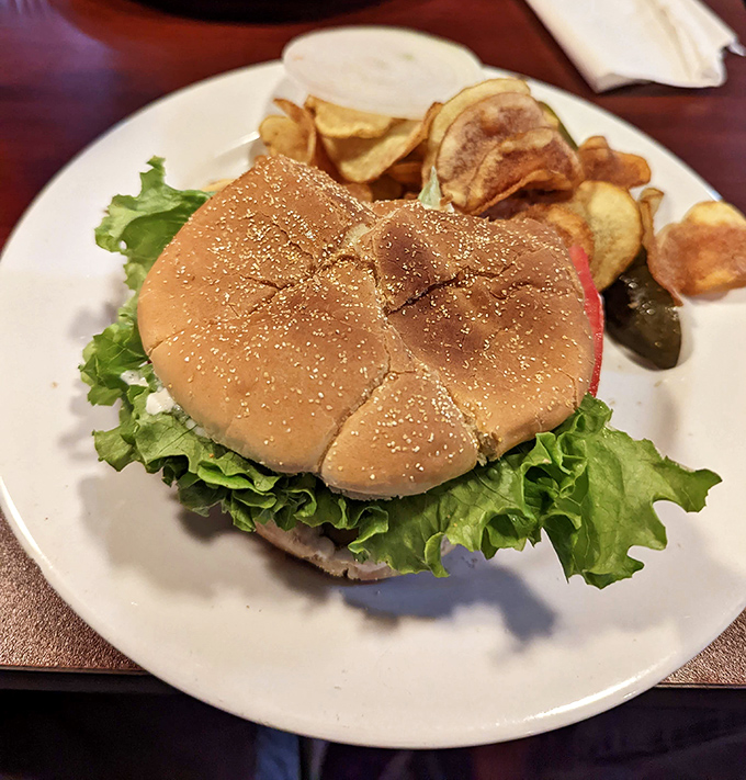 This isn't just any burger, it's a juicy masterpiece on a sesame seed throne, accompanied by homemade chips that'll ruin you for the bagged kind.