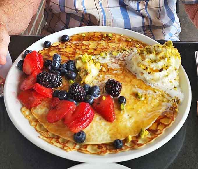 These aren't just pancakes, they're cloud-like miracles with lemon-ricotta filling and fresh berries that make breakfast feel like a special occasion worth getting up for.