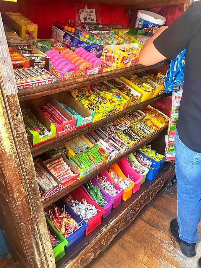 A rainbow of childhood memories fills antique wooden bins, tempting visitors with treats from simpler times.
