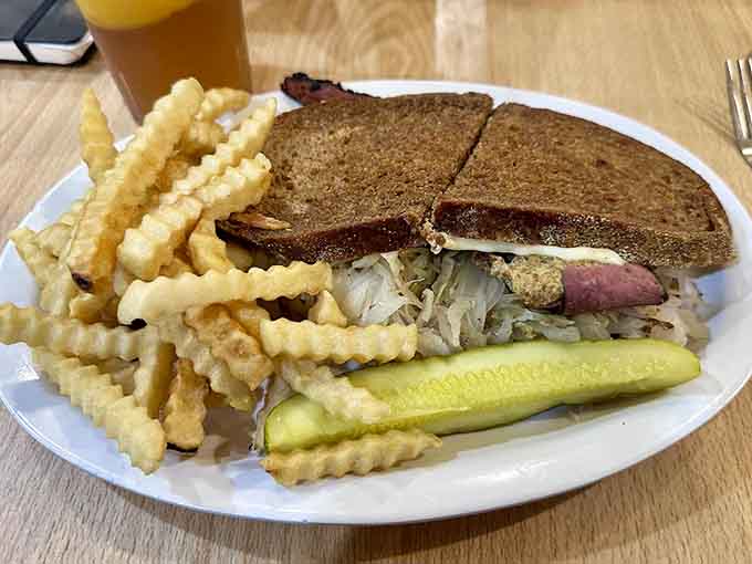The legendary Reuben arrives in all its glory, corned beef piled high between grilled rye with sauerkraut and melted Swiss perfection.