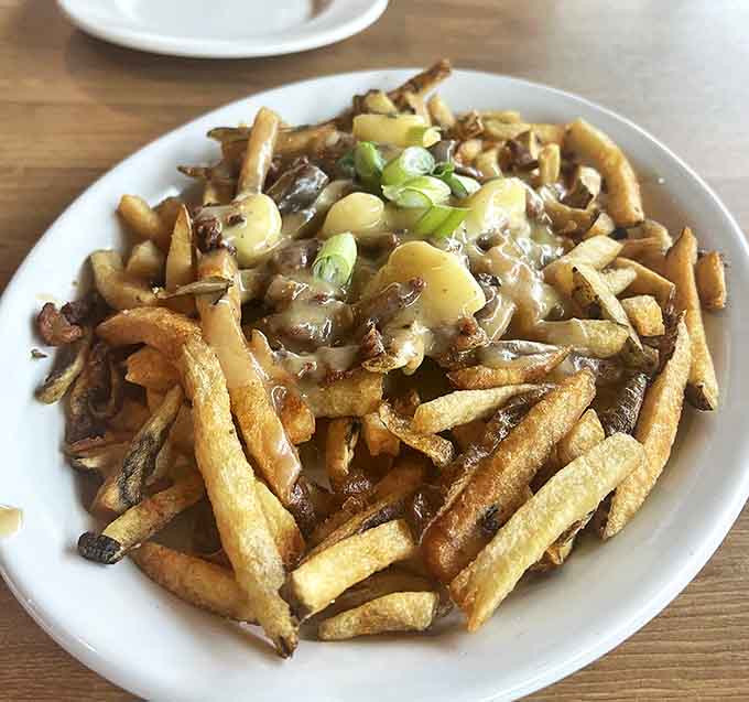 These aren't just fries &ndash; they're a gravity-defying tower of potato perfection, smothered in gravy and cheese that would make a Canadian weep with joy.