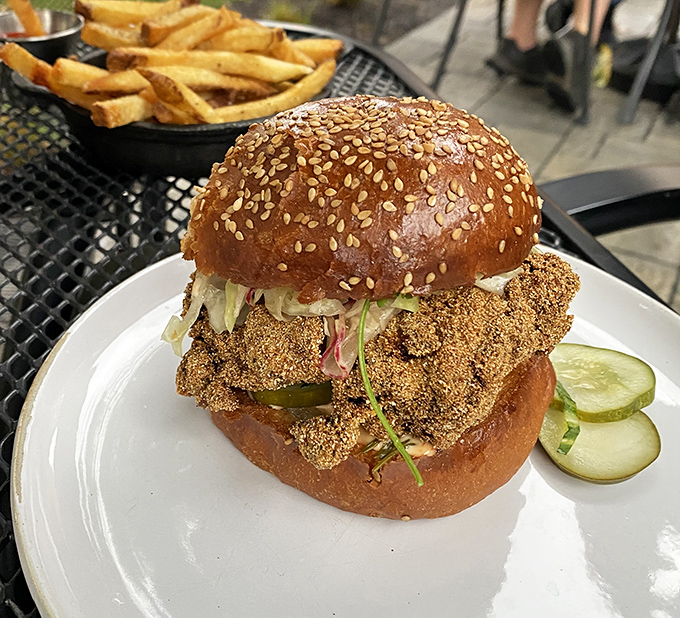 This isn't just a sandwich, it's a masterpiece &ndash; cornmeal-crusted chicken nestled in a sesame bun with house pickles and tangy slaw.