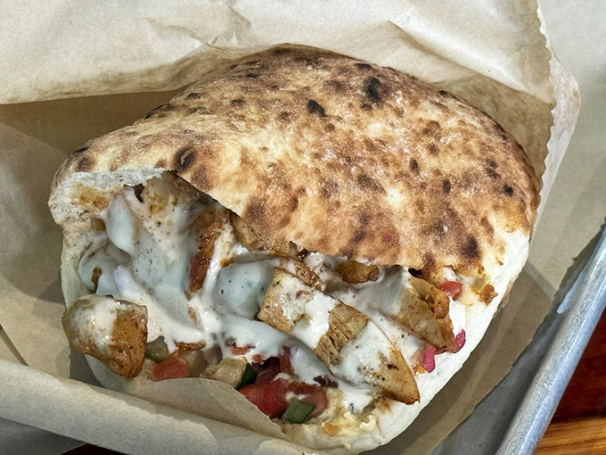Tender, spice-kissed chicken nestled in warm pita with creamy sauce &ndash; a handheld masterpiece that makes other sandwiches seem like mere snacks.