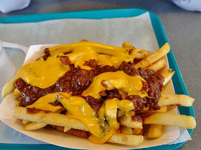 Behold the golden fries drowning in chili and cheese, a masterpiece that would make Michelangelo weep with joy.