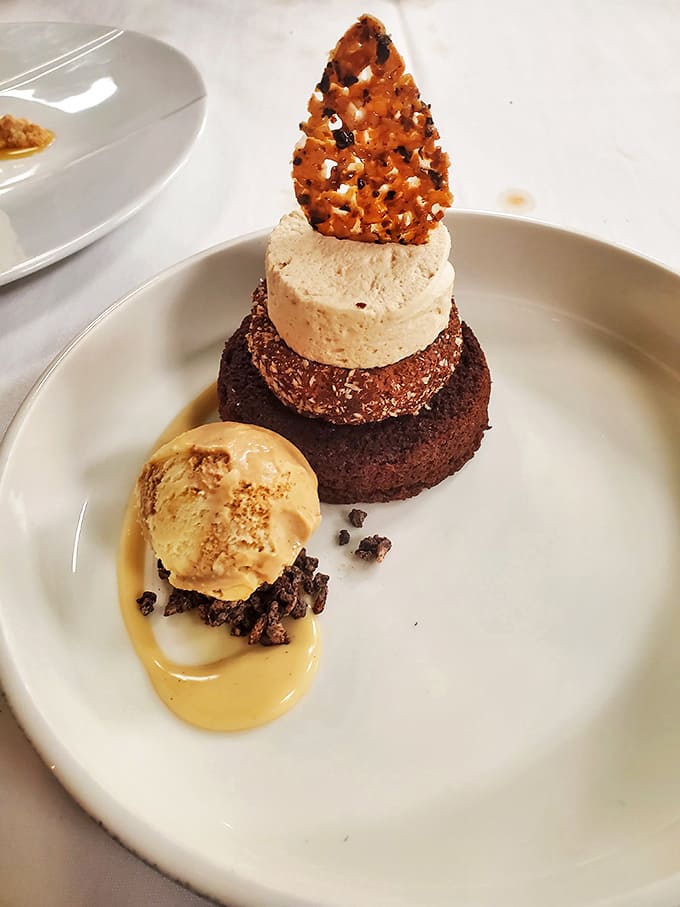 Chocolate architecture that would make Frank Lloyd Wright jealous. The dessert's precise layers create a sweet skyline worth demolishing.