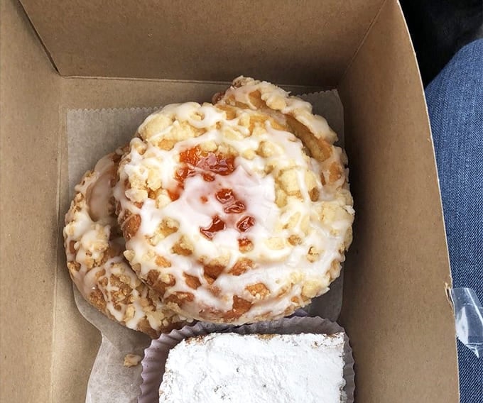 Cinnamon rolls that could end arguments: Pillowy dough spirals embrace cinnamon-sugar filling, crowned with cream cheese frosting that melts into every warm crevice.