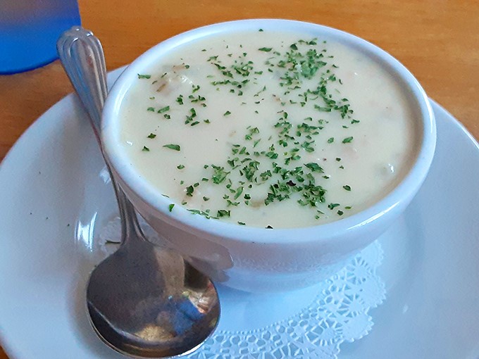 The star of the show: creamy clam chowder sprinkled with fresh herbs. This isn't just soup &ndash; it's a warm, briny hug in a bowl.