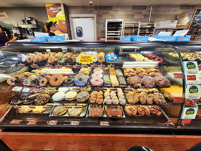 Behold the donut case of dreams, where every pastry could double as a personal flotation device in a sugary emergency.