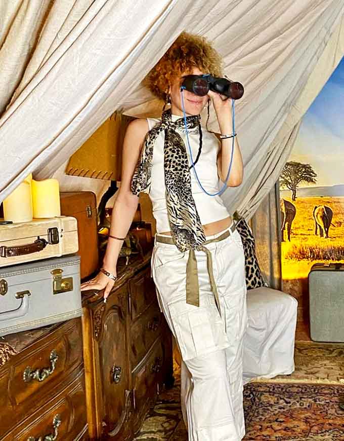 Safari adventure awaits in this tent vignette &ndash; vintage suitcases and binoculars set the stage for exploration without leaving Ohio.