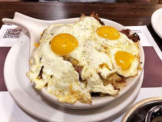 Corned beef hash topped with eggs so perfectly cooked they could make a food photographer weep tears of joy into their camera.