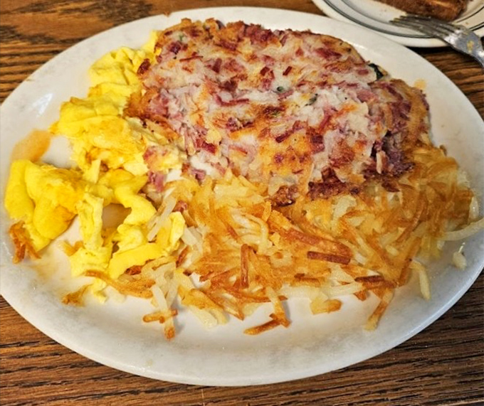 Corned beef hash that would make your grandmother jealous, paired with those famous hash browns that achieve crispy-outside, tender-inside perfection.