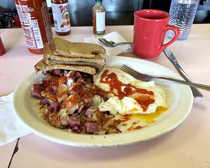 Corned beef hash done right looks like this: crispy potatoes, tender meat, perfectly cooked eggs, and toast ready to soak up every last bit of deliciousness.