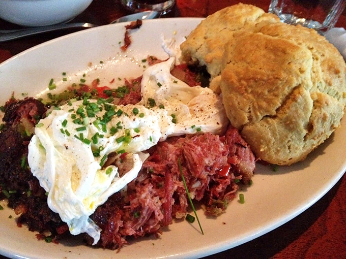 Behold the star attraction: tender corned beef hash crowned with perfectly poached eggs alongside a flaky biscuit that demands to be devoured.