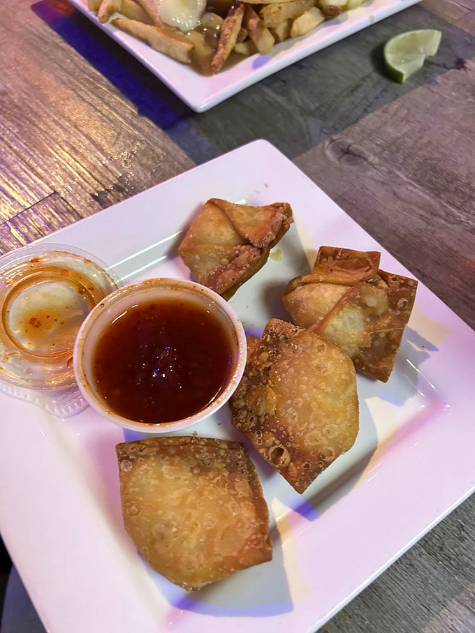 Golden-fried crab rangoon triangles &ndash; crispy on the outside, creamy on the inside &ndash; offer the perfect starter before diving into burger bliss.
