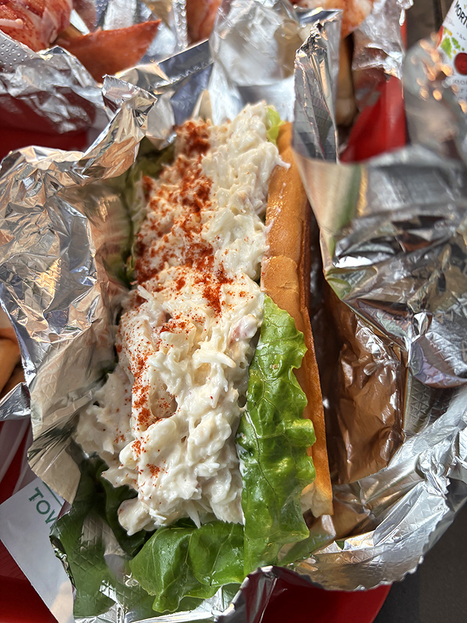 Maine's most famous lobster roll, where sweet chunks of lobster meat cascade over the sides of a perfectly toasted bun like a seafood waterfall.