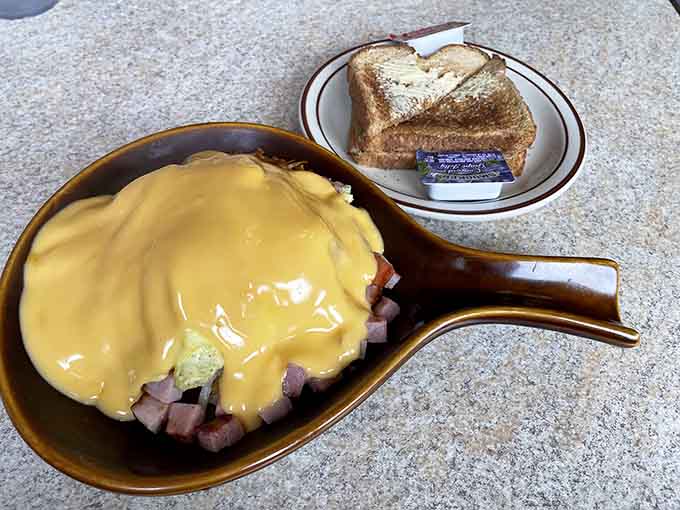 That skillet loaded with eggs, meat, and melted cheese is basically a warm hug on a plate for your hungry morning soul.