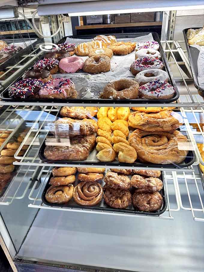 A glass-fronted treasure chest where dreams come true and diets go to die, one glorious pastry at a time.