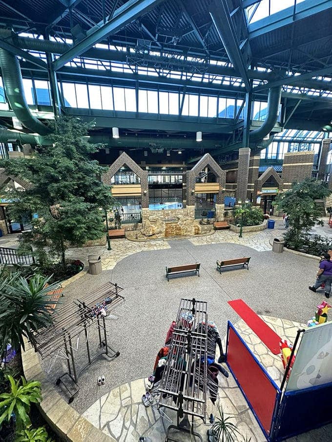 The central courtyard creates an indoor town square where families gather, complete with real trees reaching toward skylights overhead.