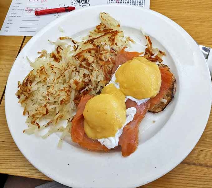 Eggs Benedict: Two golden-yolked masterpieces perched atop English muffins, draped in hollandaise so velvety it deserves its own fashion line.