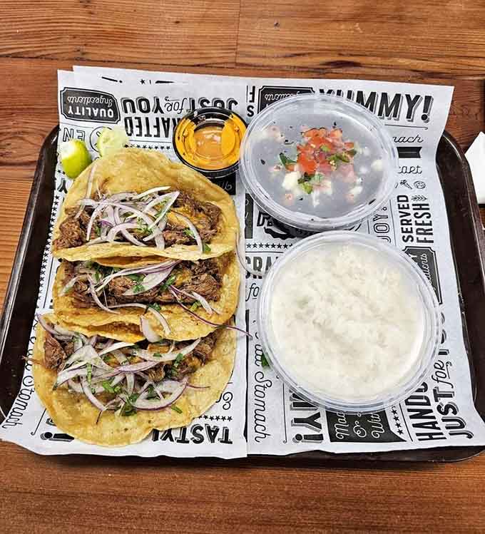 These beautifully assembled tacos arrive with fresh toppings and sides, looking like they belong in a proper restaurant, not a BP station.