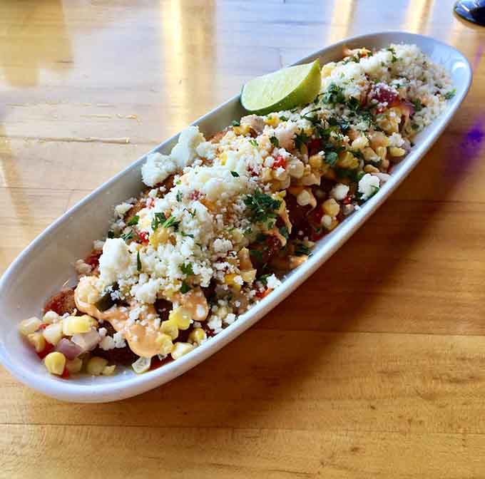 Behold the legendary fried green tomatoes, topped with a colorful array of salsas that turn Southern comfort food into culinary art.