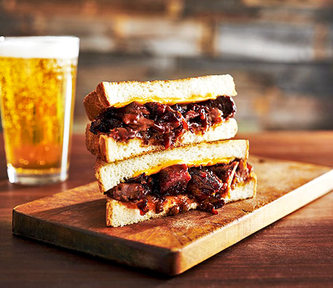 This brisket sandwich isn't just lunch&mdash;it's a tender, smoky masterpiece that makes you wonder if they've somehow managed to barbecue happiness itself.
