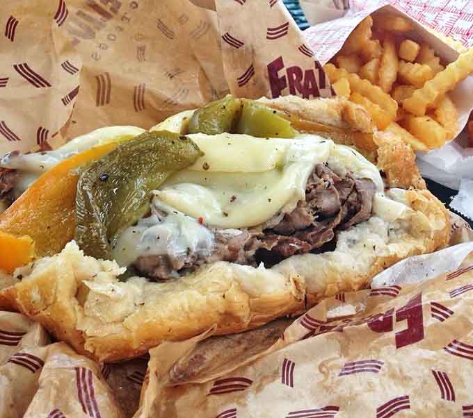 The star of the show: an Italian beef sandwich with perfectly seasoned jus, melty cheese, and those signature hot peppers, accompanied by golden crinkle-cut fries.