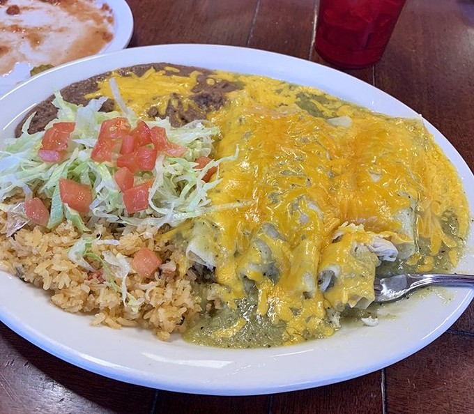 Green chicken enchiladas: Tender chicken wrapped in corn tortillas, swimming in verde sauce that's bright enough to make your taste buds do a happy dance.