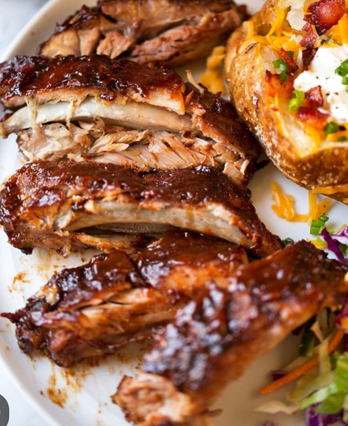 These baby back ribs glisten with promise, flanked by sides that know their supporting role perfectly.