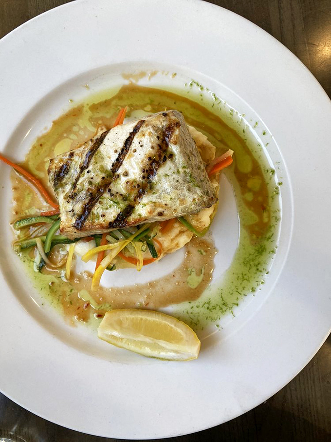 This grilled halibut might make you close your eyes involuntarily – perfectly cooked, resting on colorful julienned vegetables with a soy-ginger drizzle.