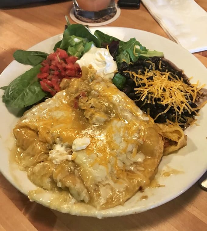 Stacked enchiladas arrive blanketed in homemade sauce and melted cheese, proving that sometimes the best Mexican food hides in unexpected places.