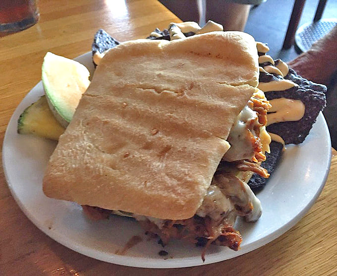The Cuban sandwich arrives pressed to perfection, with barbacoa pork and chipotle mayo creating magic between ciabatta bread slices.
