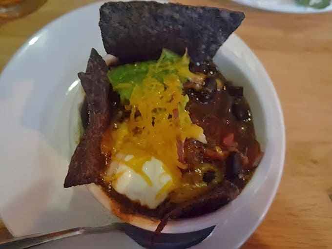 That vegetarian chili topped with sour cream and tortilla chips looks like comfort food decided to get serious about flavor.