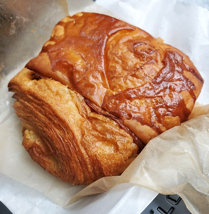 This golden masterpiece isn't just a croissant &ndash; it's butter's highest calling, with layers that shatter like delicious glass.