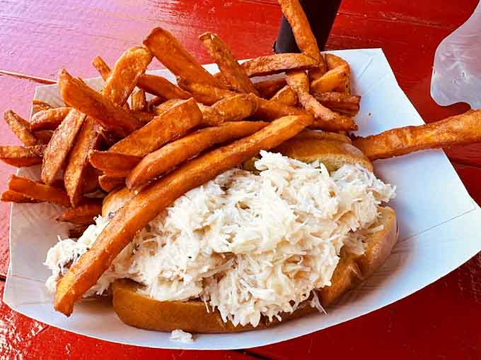 Fresh crab piled high on a toasted roll with crispy fries proves seafood doesn't need fancy plating.