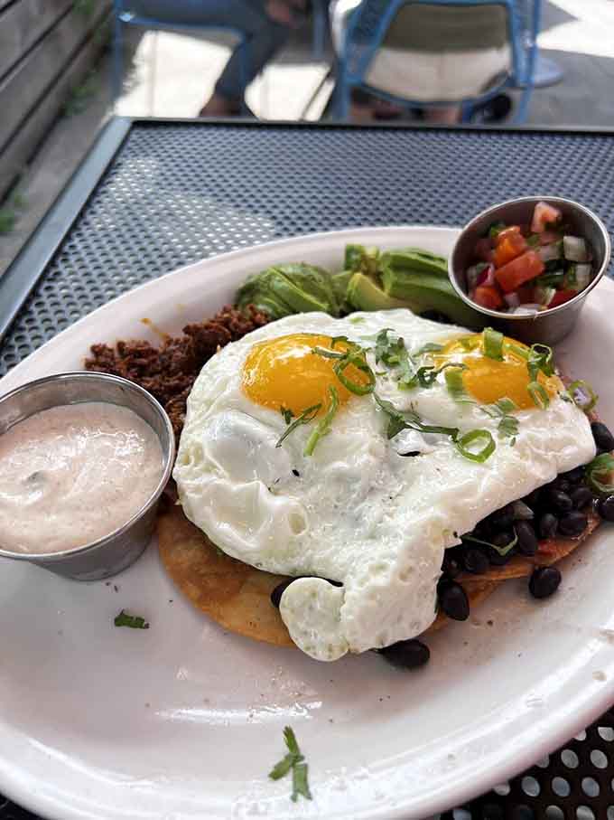 Behold the Huevos Rancheros in all their glory, eggs perched atop crispy tortillas with enough toppings to make your breakfast dreams come true spectacularly.
