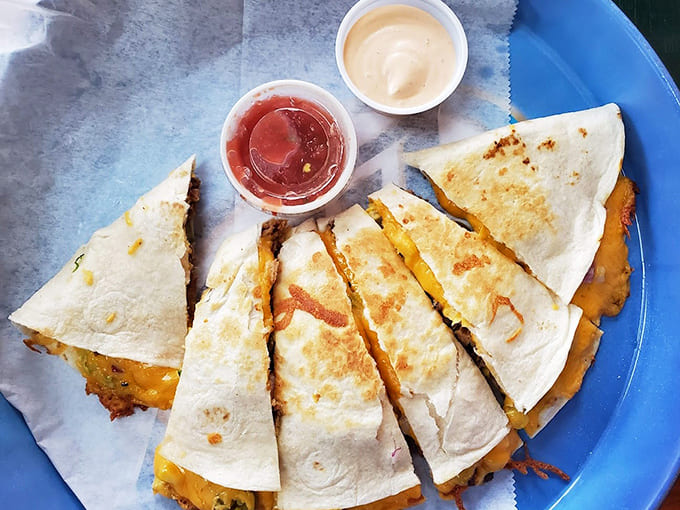 Golden quesadilla triangles reveal layers of melted cheese that stretch like they're auditioning for a mozzarella commercial.