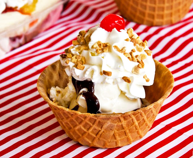 A perfect sundae nestled in a homemade waffle bowl &ndash; architecture you can eat, topped with whipped cream and that obligatory cherry.