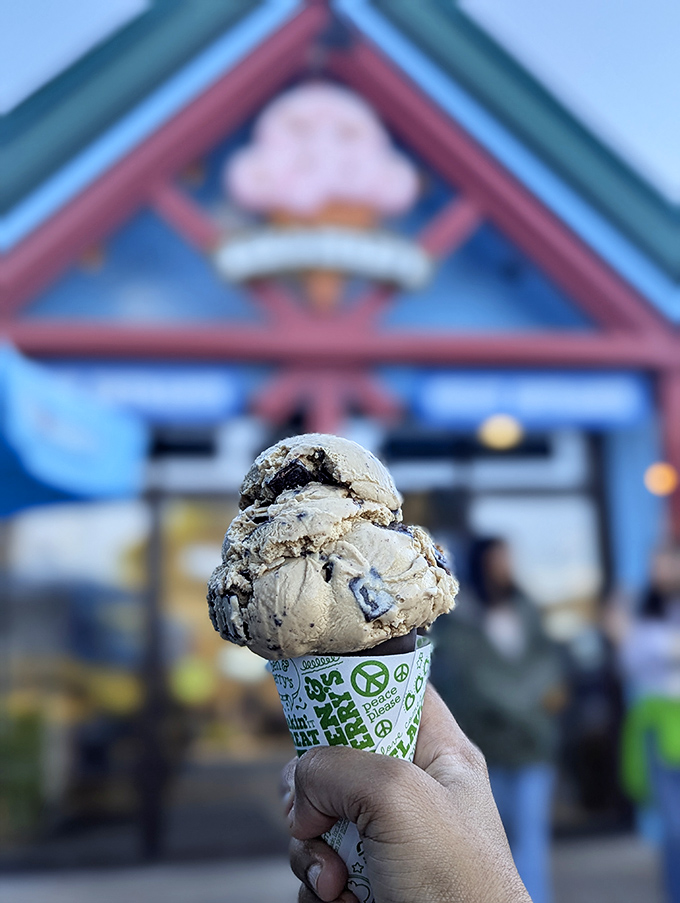 A scoop of chunky chocolate goodness held against the iconic storefront. This survivor avoided the graveyard fate that befell so many of its creamy brethren.